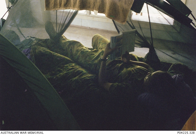 Captain Rachel Leal of 1st Intelligence Battalion reads a book, while ...