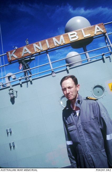 Portrait of Captain (Capt) Peter Jones, AM, RAN, in front of a ...