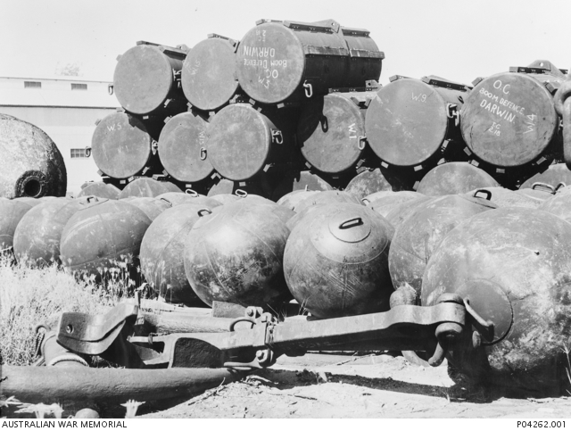 A stockpile of three and four ton anchors, spherical floats and buoys ...