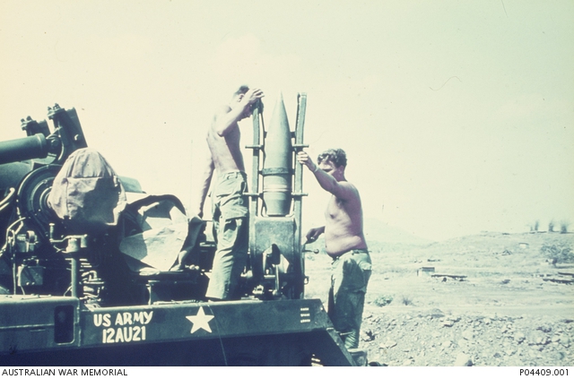 Two unidentified gunners preparing to load an 8 inch shell into a ...