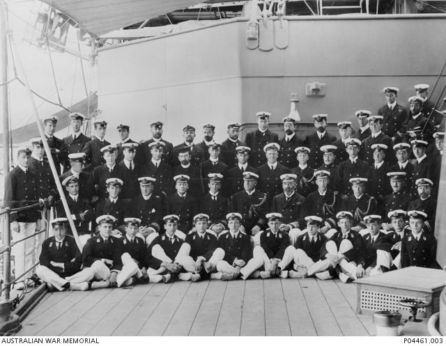 Group portrait of officers and crew aboard HMS King Alfred, a Drake ...