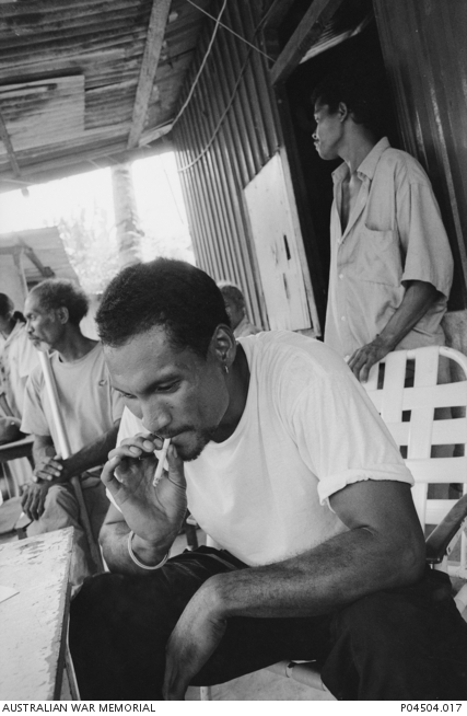 Portrait of John da Silva, relaxing with family members in the Dili suburb of Becora. Da Silva ...