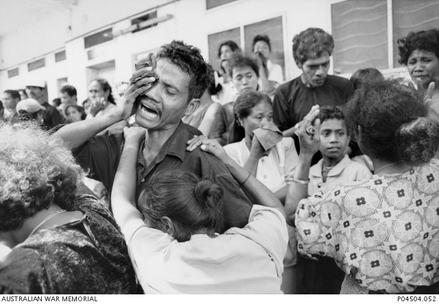 Aitarak militia members, and relatives, mourn the death of militia ...