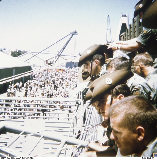 Soldiers watch the crowd dispersing after farewelling members of 3rd ...