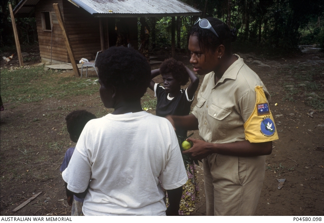 An Australian member of the Peace Monitoring Group (PMG), wearing a PMG ...