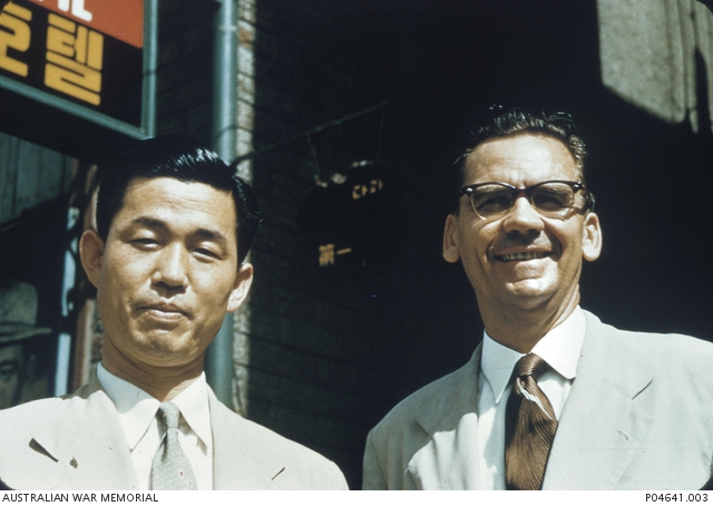 Informal portrait of two unidentified men in a South Korean street. The ...