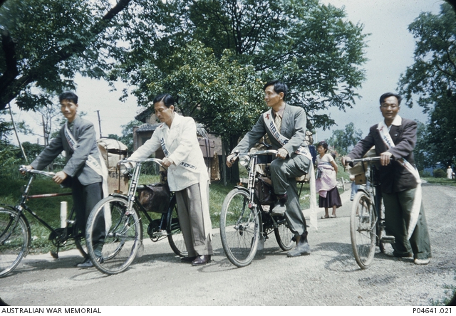Portrait of four young South Korean men preparing to travel by bicycle ...