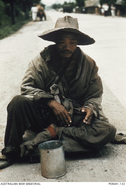 Korean refugee begging beside a road. One of a series of photographs ...
