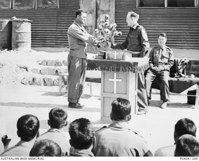 Douglas (Doug) Bushby being presented with a bunch flowers by a North ...