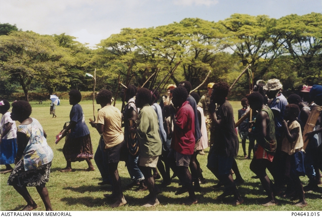 Local men conduct a traditional spear dance to celebrate the signing of ...