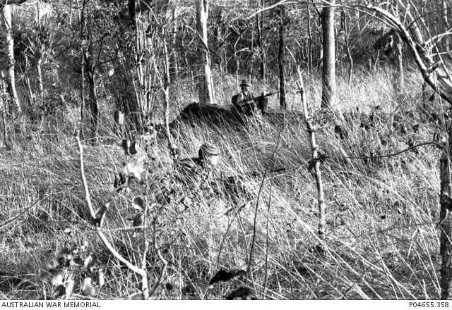 Two members of A Company, 7RAR, are ready to fire their weapons as they ...