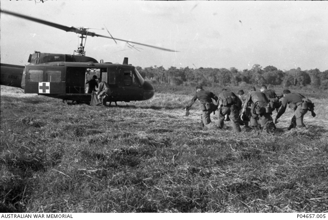 Members of 11 Platoon, D Company, 6RAR (right), carry a seriously ...