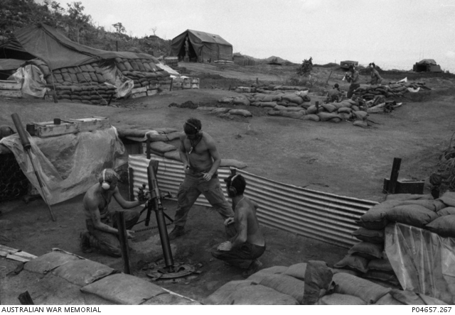 Members of the Mortar Section of 7RAR are about to fire an 81mm mortar ...