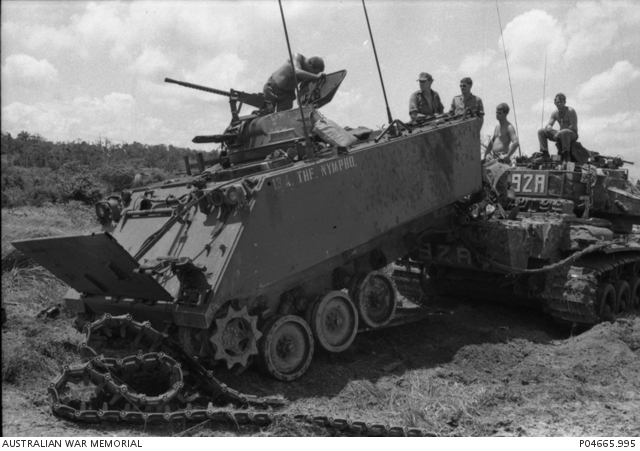 Troopers inspect the damage to an M113A1 Armoured Personnel Carrier ...