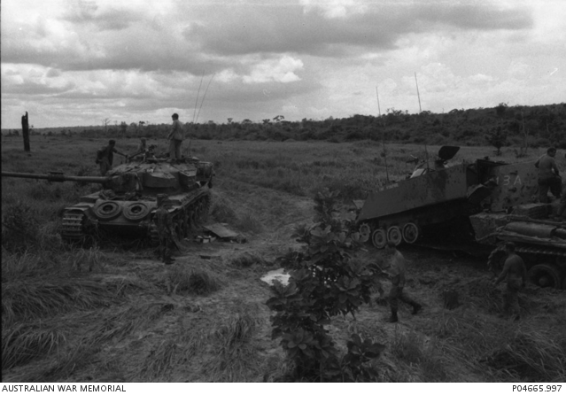 At right, the rear of a badly damaged M113A1 Armoured Personnel Carrier ...