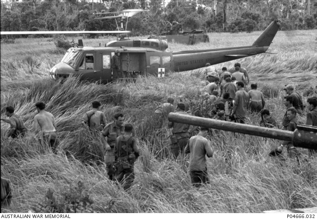 Two stretcher parties of Australian soldiers (right) carry casualties ...