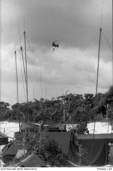 Radio masts rise above tents, a hoochie and an M113A1 Armoured ...