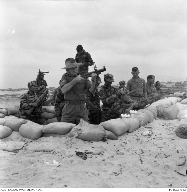 Standing in a sandbagged bunker, 35461 Warrant Officer 2 (WO2) Keith ...
