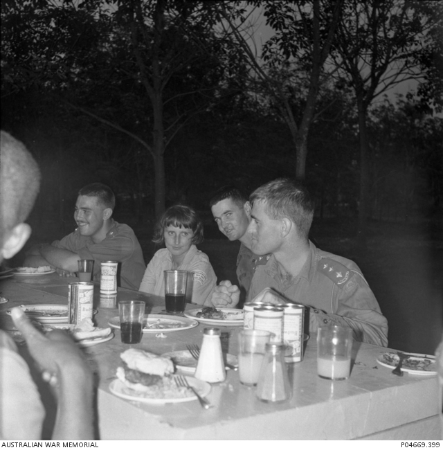 Officers, senior NCOs and guests enjoy a meal and drinks in the ...