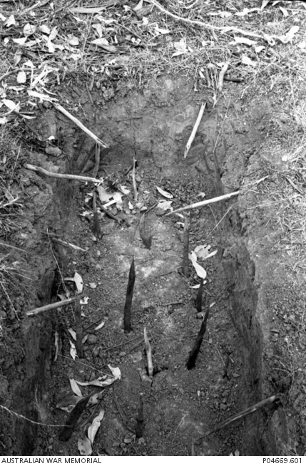 A replica of a Viet Cong booby trap is set up as an aid to the ...