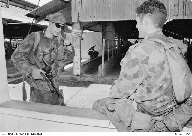 Two unidentified RAAF servicemen provide security at the Dili Beach ...