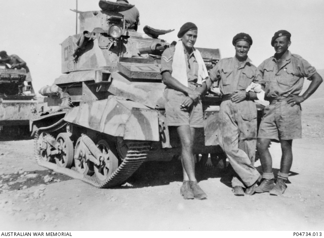 Three members of a tank unit attached to the 9th Division standing ...