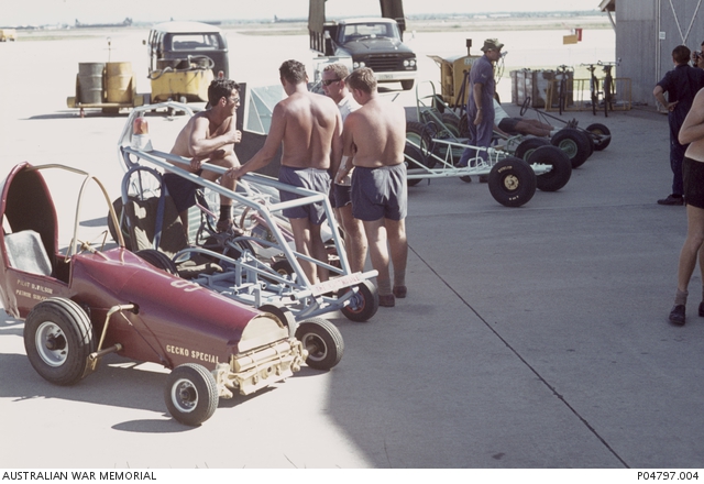 Unidentified members of No 2 Squadron, RAAF, standing outside a hangar ...
