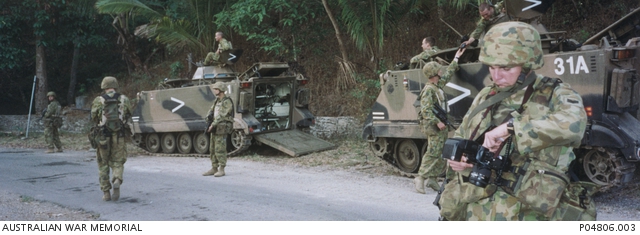 Armed members of Charlie Company, 5/7th Battalion, The Royal Australian ...
