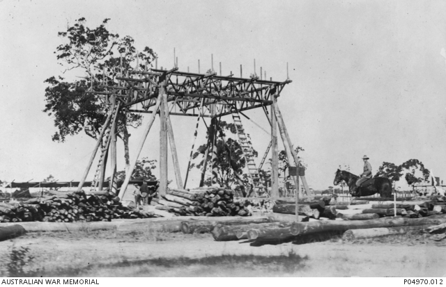 An unidentified Australian Army guard on horseback supervises internees ...
