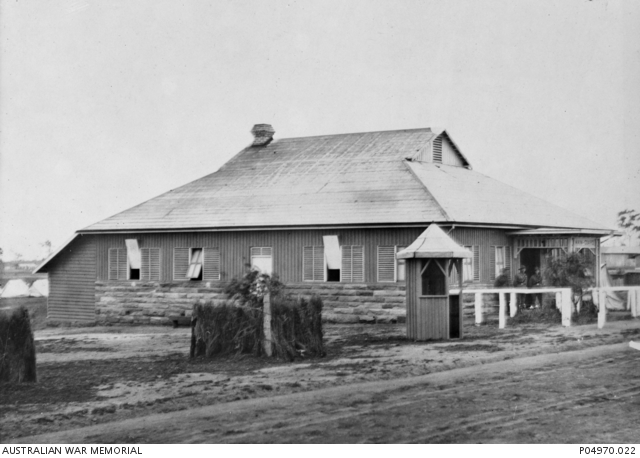 Three unidentified Australian Army camp guards stand outside the main ...