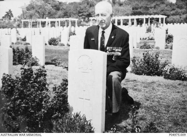 Lewis David Price kneels behind the grave of Major Herbert Hamilton ...