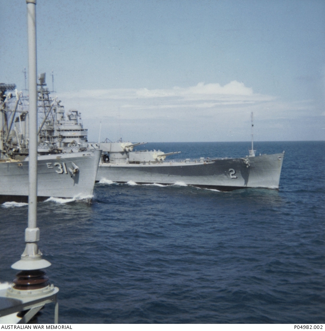 Replenishment at sea (RAS) of United States Navy (USN) heavy cruiser ...