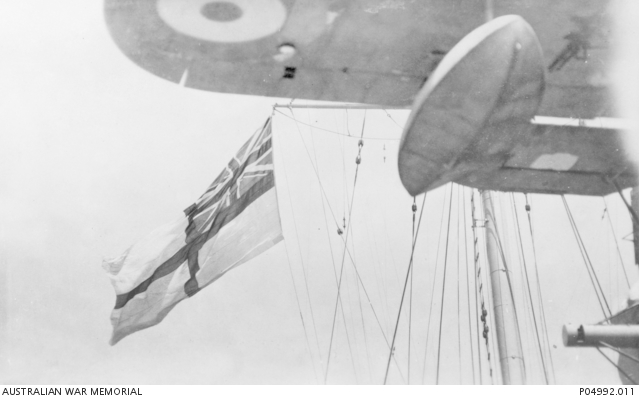 The white ensign streams from the yard arm of the County class heavy ...