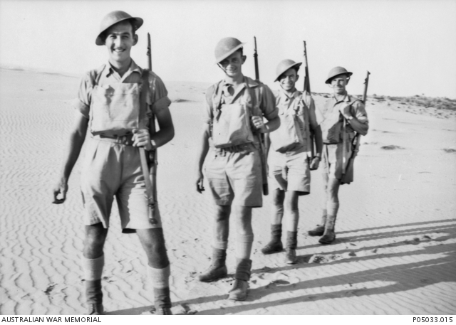 Four unidentified smiling Australian soldiers prepare for an evening ...