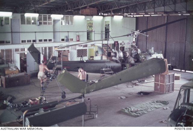 Members of No 9 Squadron, RAAF, (9 Sqn), working on an Iroquois UH-1B ...