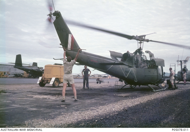 Airframe fitter, 43592 Rob Gee, No 9 Squadron (9 Sqn), RAAF, carrying ...
