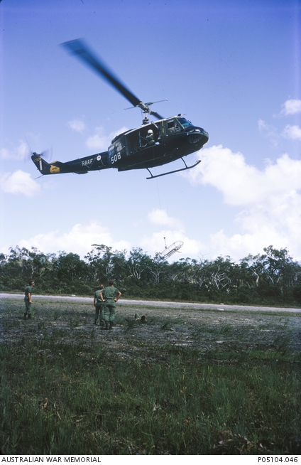 A No 9 Squadron, RAAF, Iroquois helicopter number 507 winching a empty ...