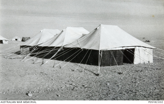 "Tents sunk in sand for protection against bomb splinters." Image from ...