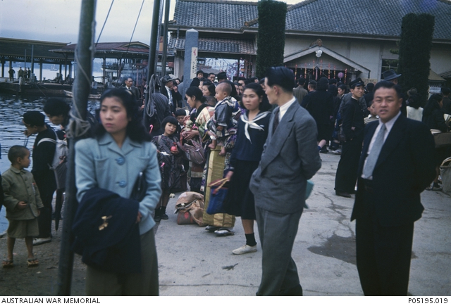 A waterfront area of Miyajima. Japanese people, including businessmen ...