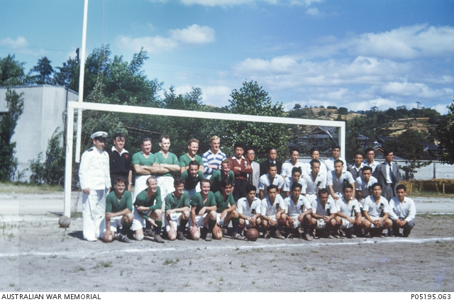 Group portrait of the members of two soccer teams, referee, coaches and ...