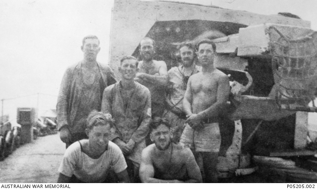 Informal group portrait of members of the No 1 Gun's crew in front of a ...