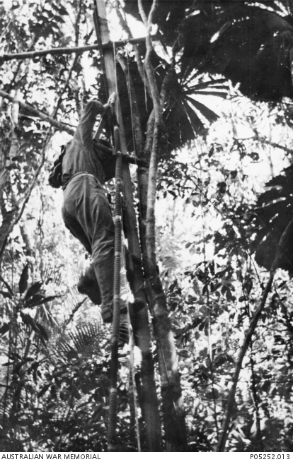 A volunteer in full protective clothing attaching equipment to the ...