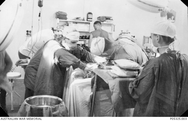 An injured soldier being operated on by unidentified surgeons and ...