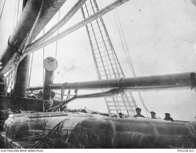 Ice covers the deck and rigging of the German armed merchant raider ...
