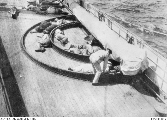 Unidentified sailors sleeping in the sunshine on the deck of the German ...