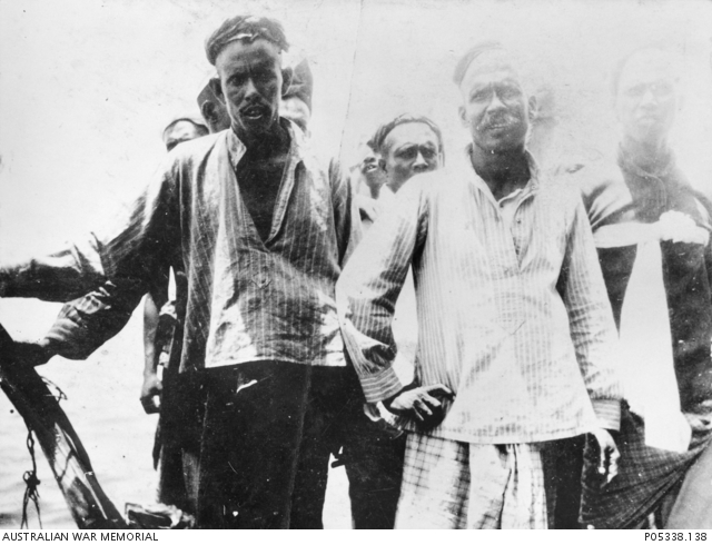 A group of unidentified local men from the Suvadiva Atoll in the ...