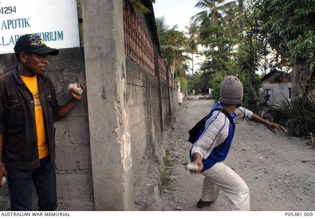 In the Comora district, youths throw rocks during a clash between rival ...
