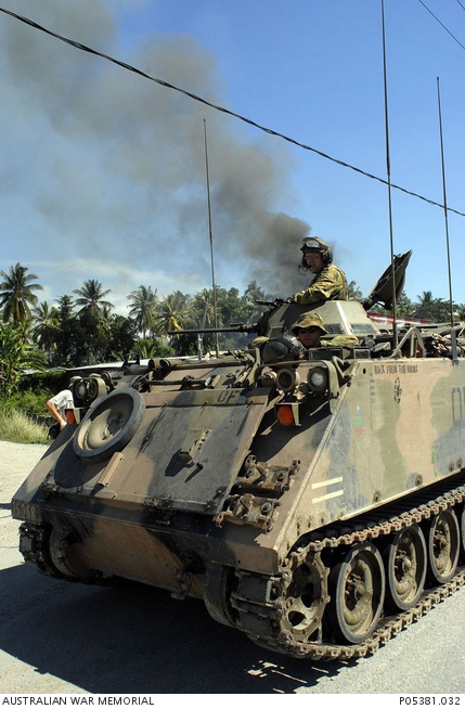 Australian troops travelling in an M113 armoured personnel carrier (APC ...