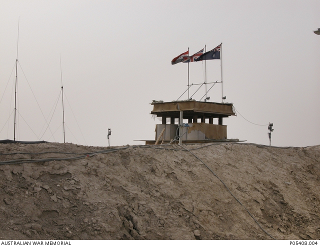 Three flags, Iraqi, British and Australian, flying at the front gate of ...