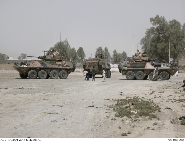 Iraqi children gathered in front of three Australian Light Armoured ...
